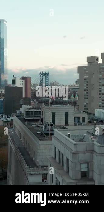 Vertical video: Fly high above narrow street between high rise ...