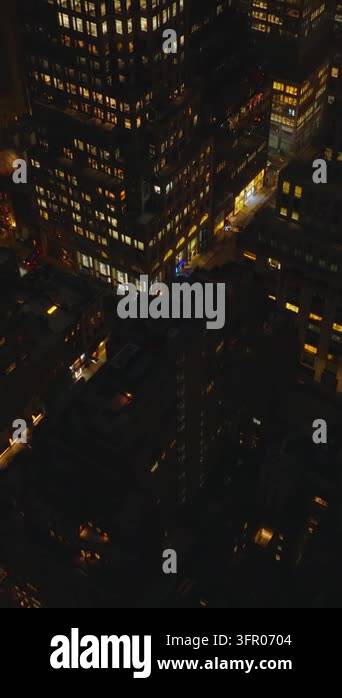 Vertical video: High angle view of streets in night city. Tilt up ...