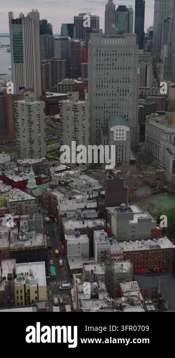 Vertical video: Fly above town development. High angle view of ...