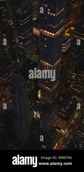 Vertical video: Downtown at night. High angle view of high rise ...