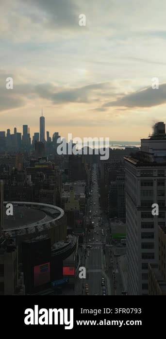 Vertical video: Forwards fly between high rise buildings in metropolis ...