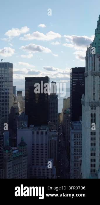 Vertical video: Forwards fly through downtown. Elevated view of ...