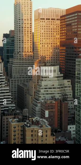 Vertical video: High rise buildings in midtown at dusk. Tall office ...