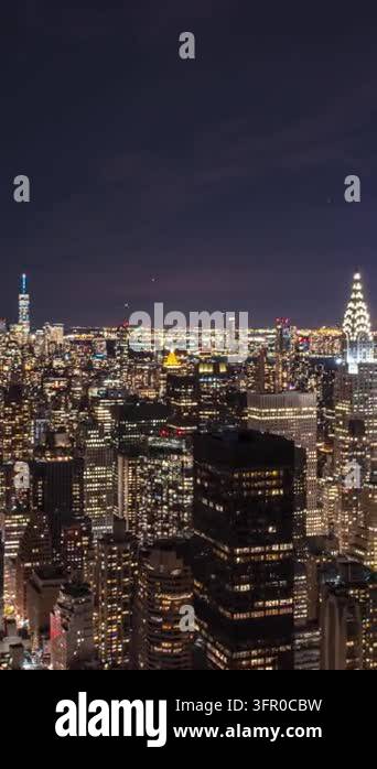 Vertical video: Fly above city downtown at night. Hyperlapse of ...