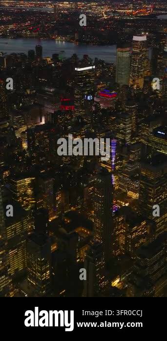 Vertical video: Aerial view of night city. Various illuminated high ...