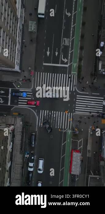 Vertical video: Top down ascending footage of pars passing road ...