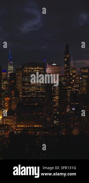 Vertical video: Slider of tall downtown skyscrapers against twilight ...