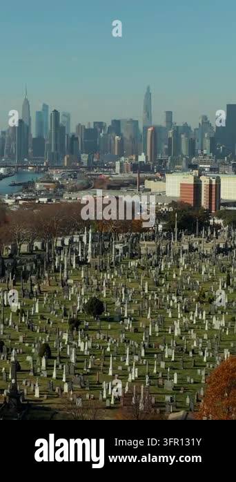 Vertical video: Forwards fly above historic Calvary Cemetery with tall ...