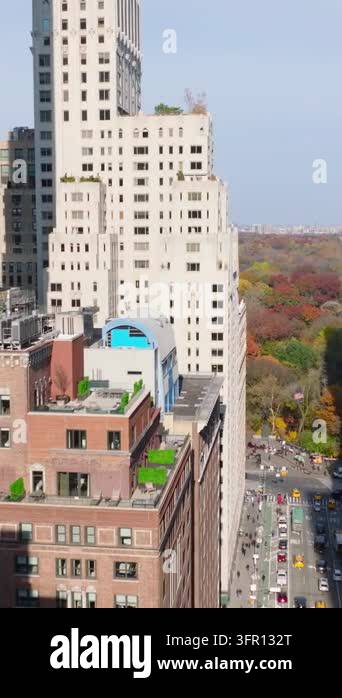 Vertical video: Forwards fly between high rise downtown buildings ...