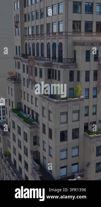 Vertical video: Ascending aerial footage of high rise luxurious hotel ...