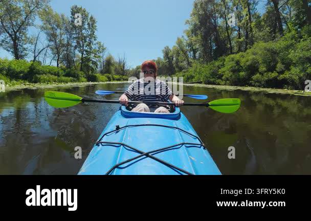 Action camera front POV shot from a blue tandem kayak showing a red ...