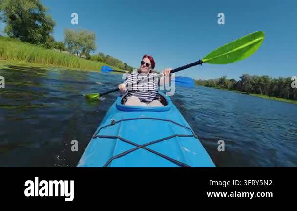 Point of view action camera shot from the bow of a blue tandem kayak ...
