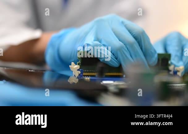 technician working in a lab, with the electronic circuit board, the ...