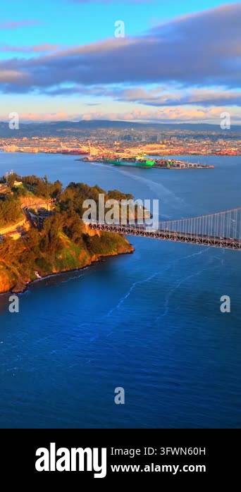 San Francisco Bay Bridge and cargo ship, California. Suspension bridge ...