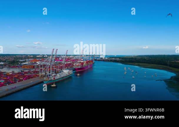 Aerial view of a large container ship moving through a busy port with ...