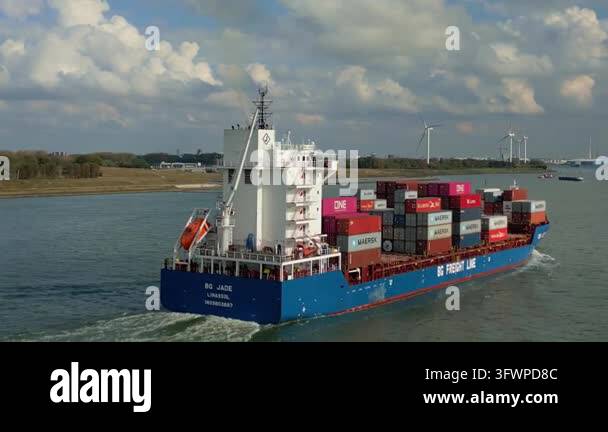 Large blue and white cargo ship transporting colorful shipping ...