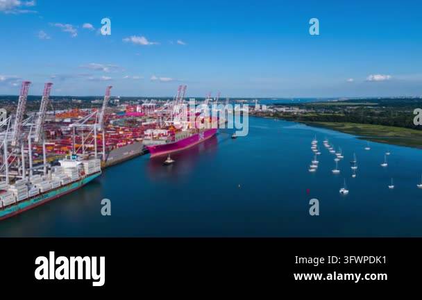 Aerial view of a busy container port with large cargo ships and cranes ...