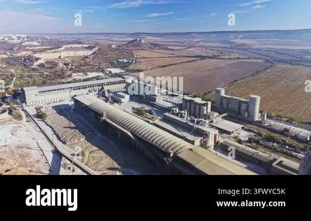 Aerial view of an industrial complex with long roofed structures and ...