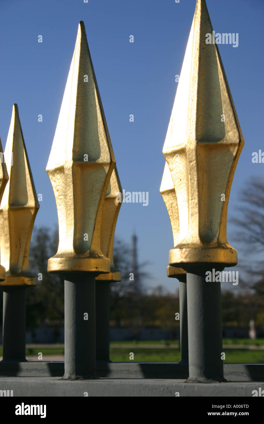 Gold topped railings in Tuileries gardens, Eiffel Tower in Background ...