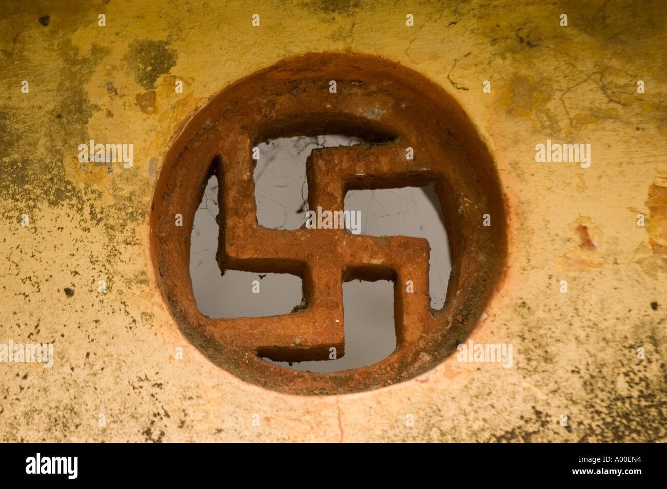 Red buddhist swastica carved in a circular window at Sarnath, Varanasi ...
