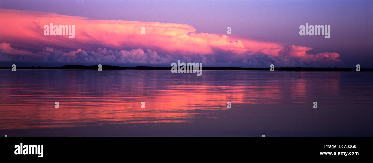 Lake reflects clearing summer rain storm burned red by setting sun Big ...