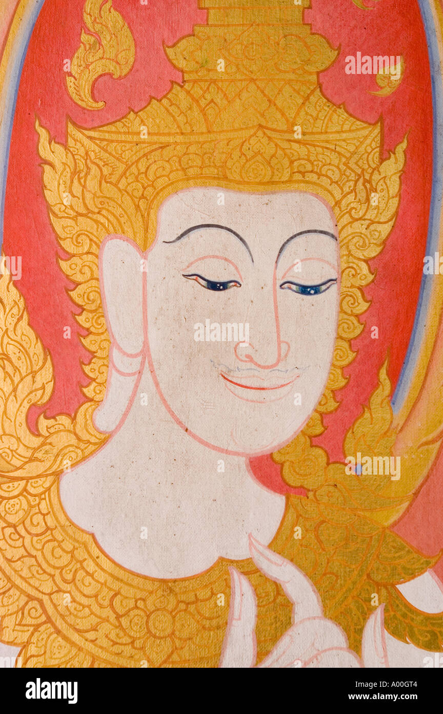 Close up of a smiling golden buddhist man face mural at Thai Wat temple ...