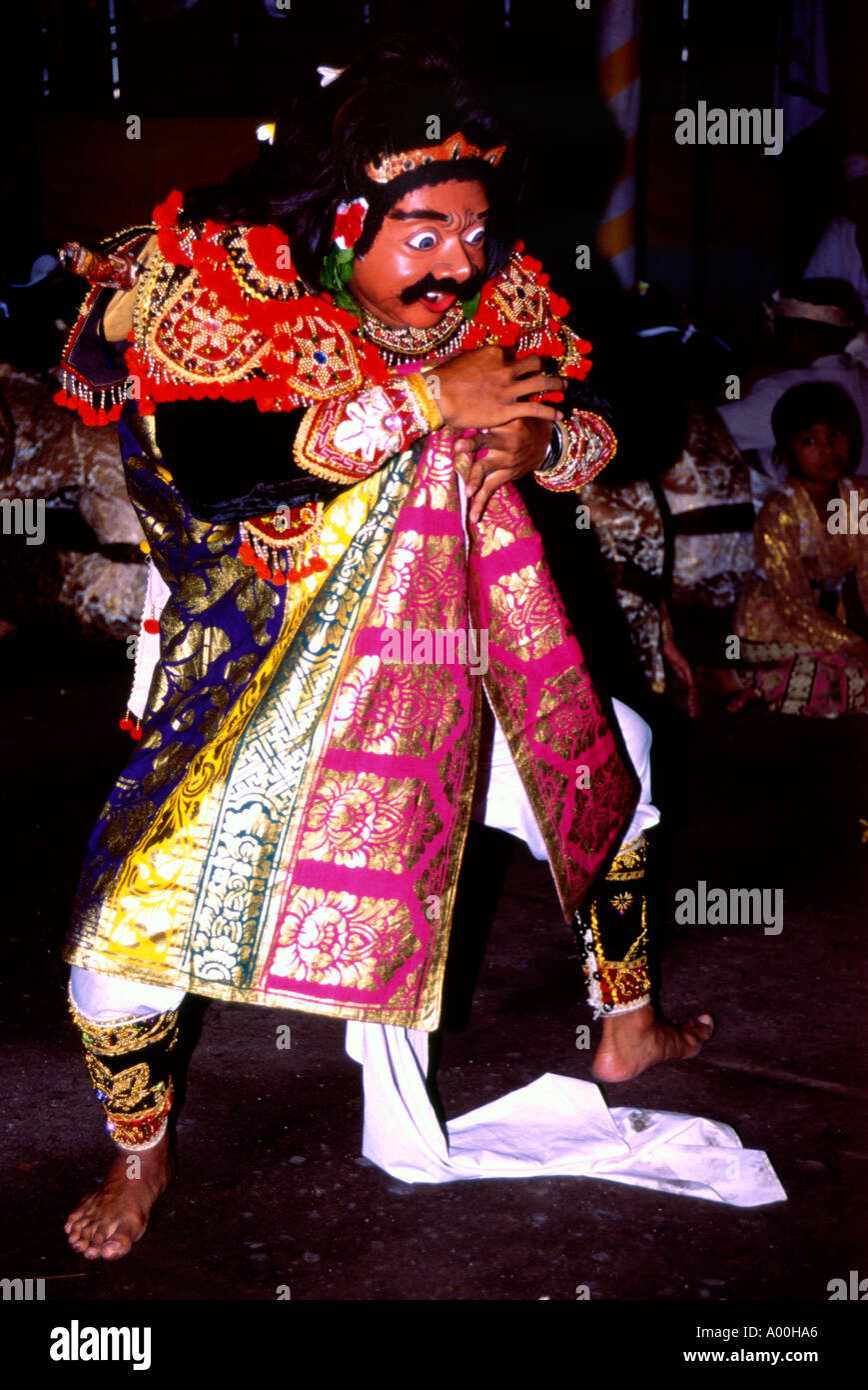 male masked dancer performs a traditional dance in traditional dress at ...