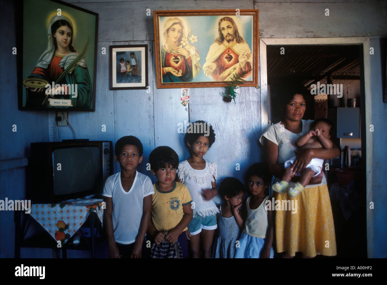 Catholic iconography decorating the walls of slum house Brasilia Brazil ...