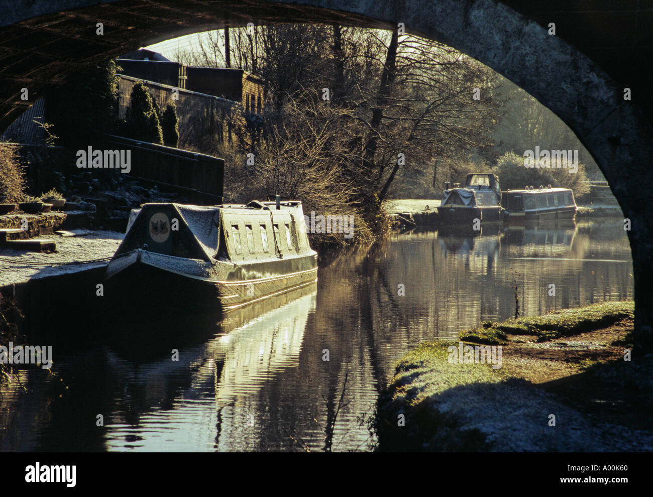 A boat moored by a bridge on the Leeds liverpool canal in the village ...