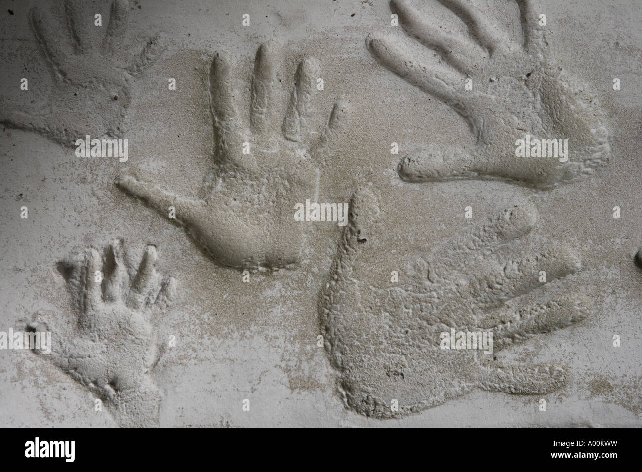 Different sized hand prints in cement Stock Photo - Alamy