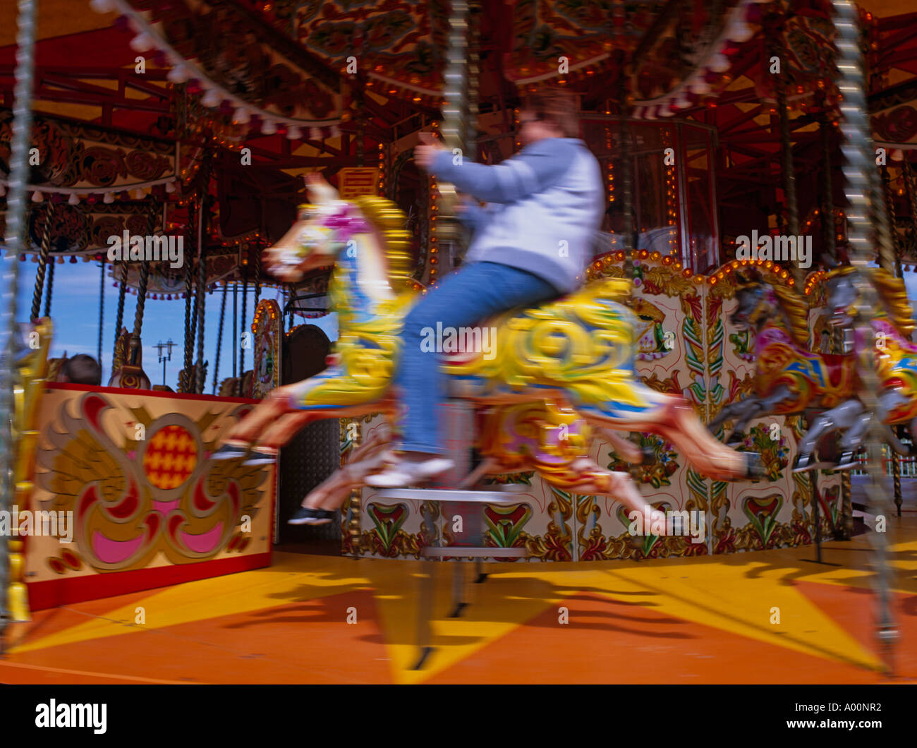 Child enjoying carousel, Rhyl Fun Fair, Denbighshire, North Wales, UK ...