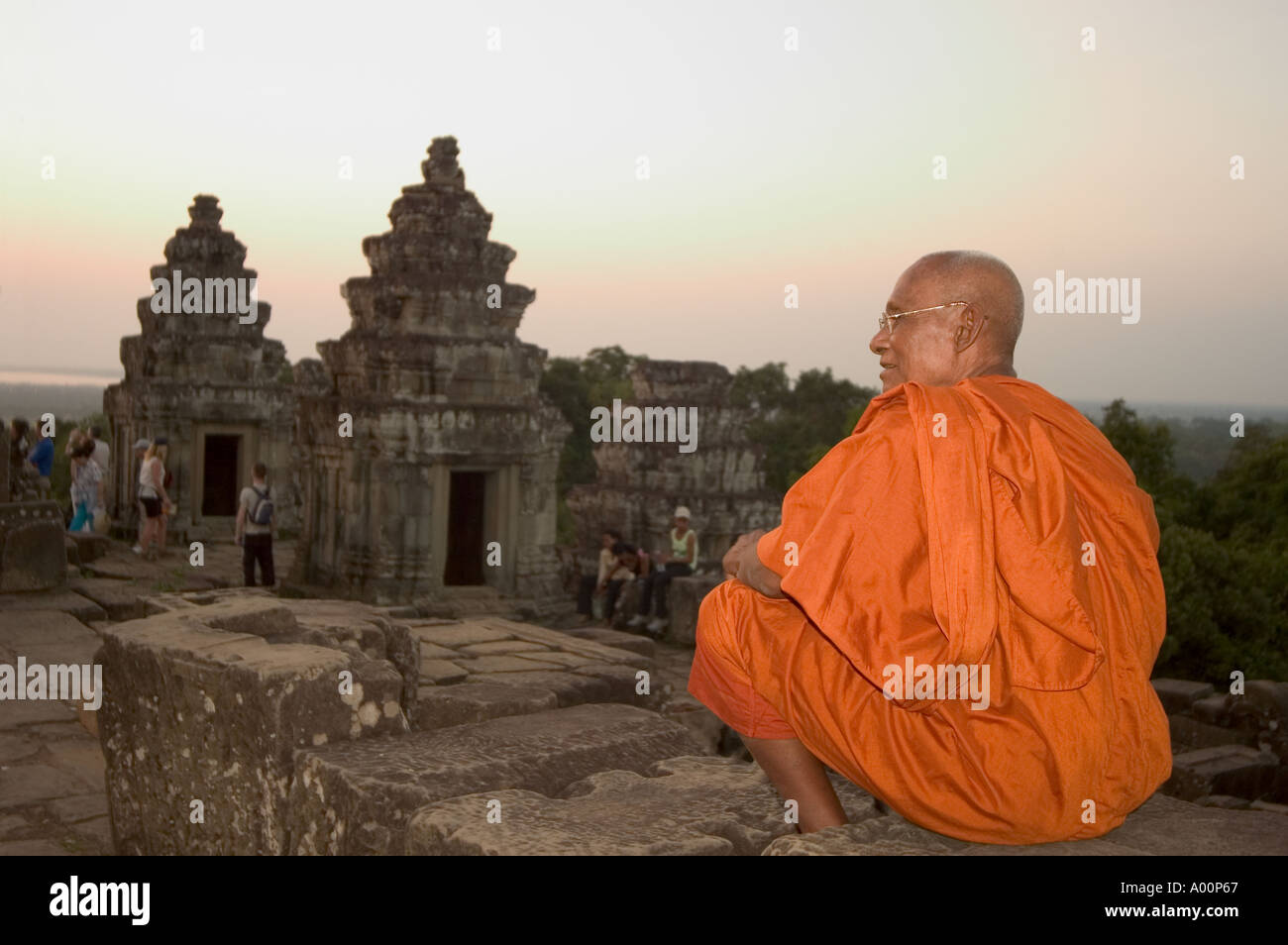 monk viewing sunset Phnom Bakeng temple Ankor Wat Cambodia South East ...