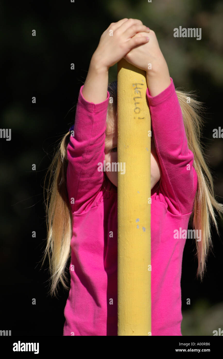 girl standing behind post that says hello Stock Photo - Alamy