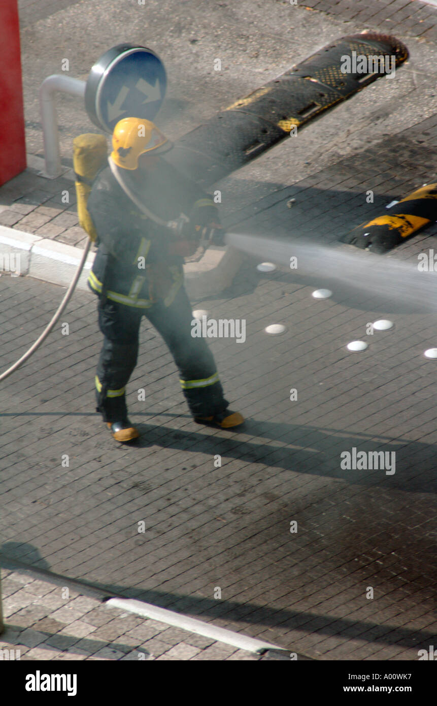 fire fighters putting out the flames with water jets during a fire ...