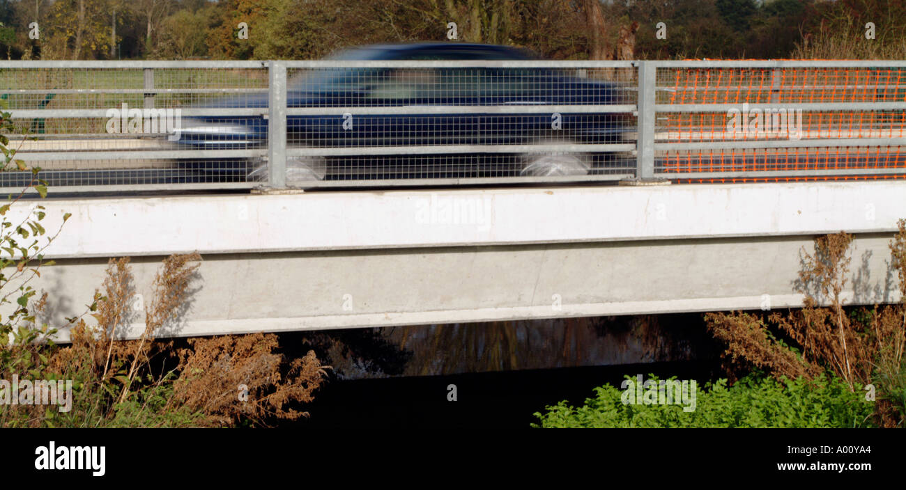 Blurred car travelling over bridge Stock Photo - Alamy