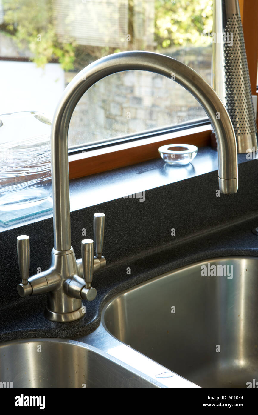 brushed steel tap unit in kitchen of modern house Stock Photo - Alamy