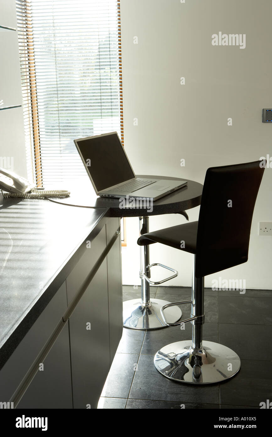 breakfast bar with Apple Mac laptop computer on worktop Stock Photo - Alamy