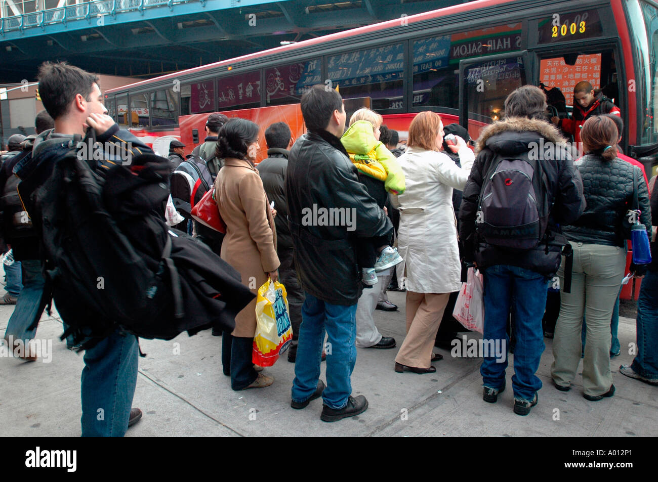 Thanksgiving travelers board buses in Chinatown on Market Street People ...