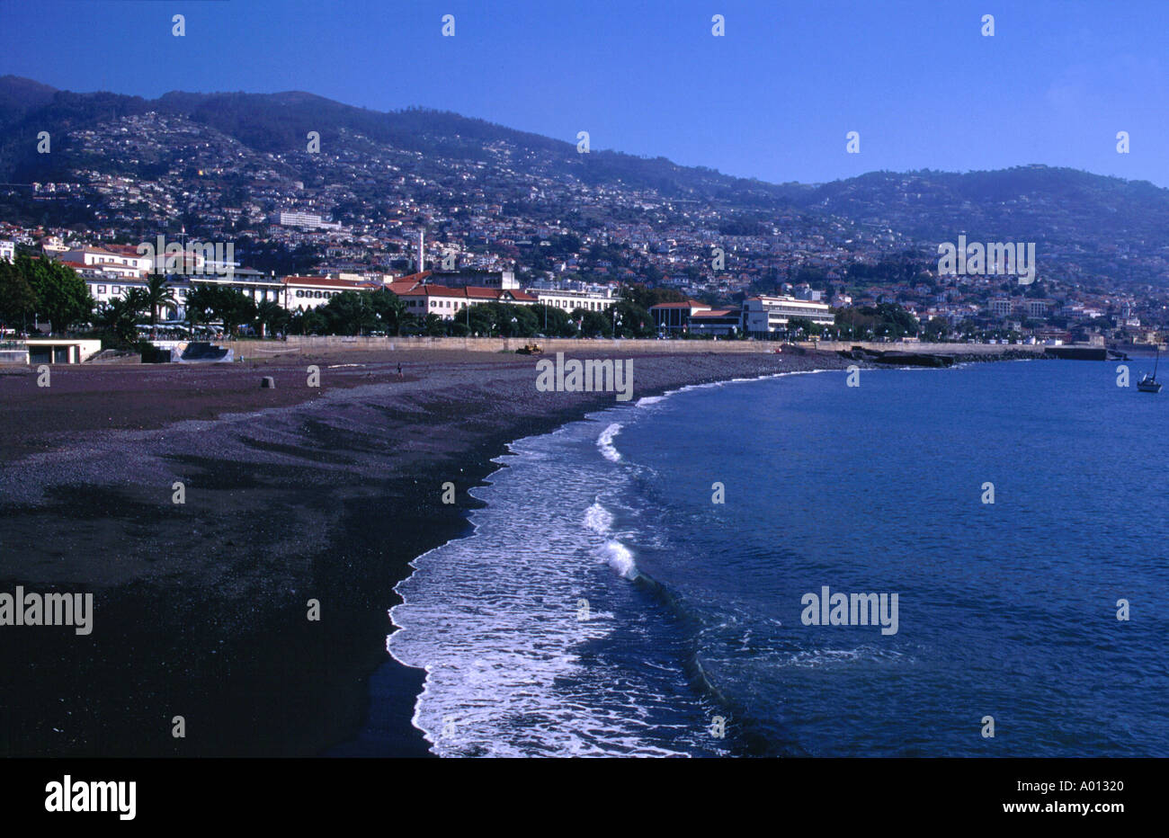 Waves lap the beach of volcanic sand Funchal Madeira Stock Photo - Alamy