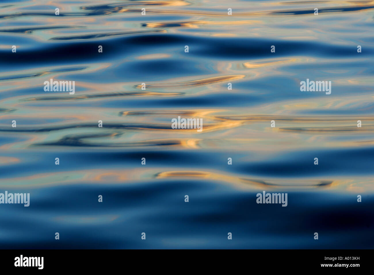 Reflections in calm body of water Stock Photo - Alamy