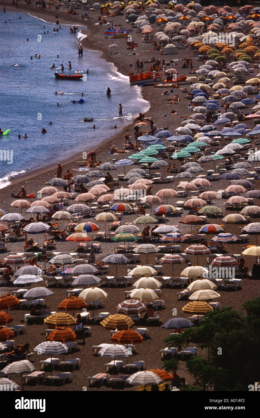 Beach crowded with umbrellas Rhodes Greece Stock Photo - Alamy