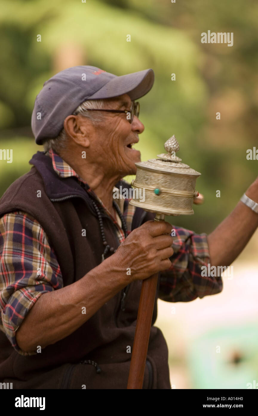 Old Tibetan man with big buddhist prayer wheel Dharamsala Himachal ...