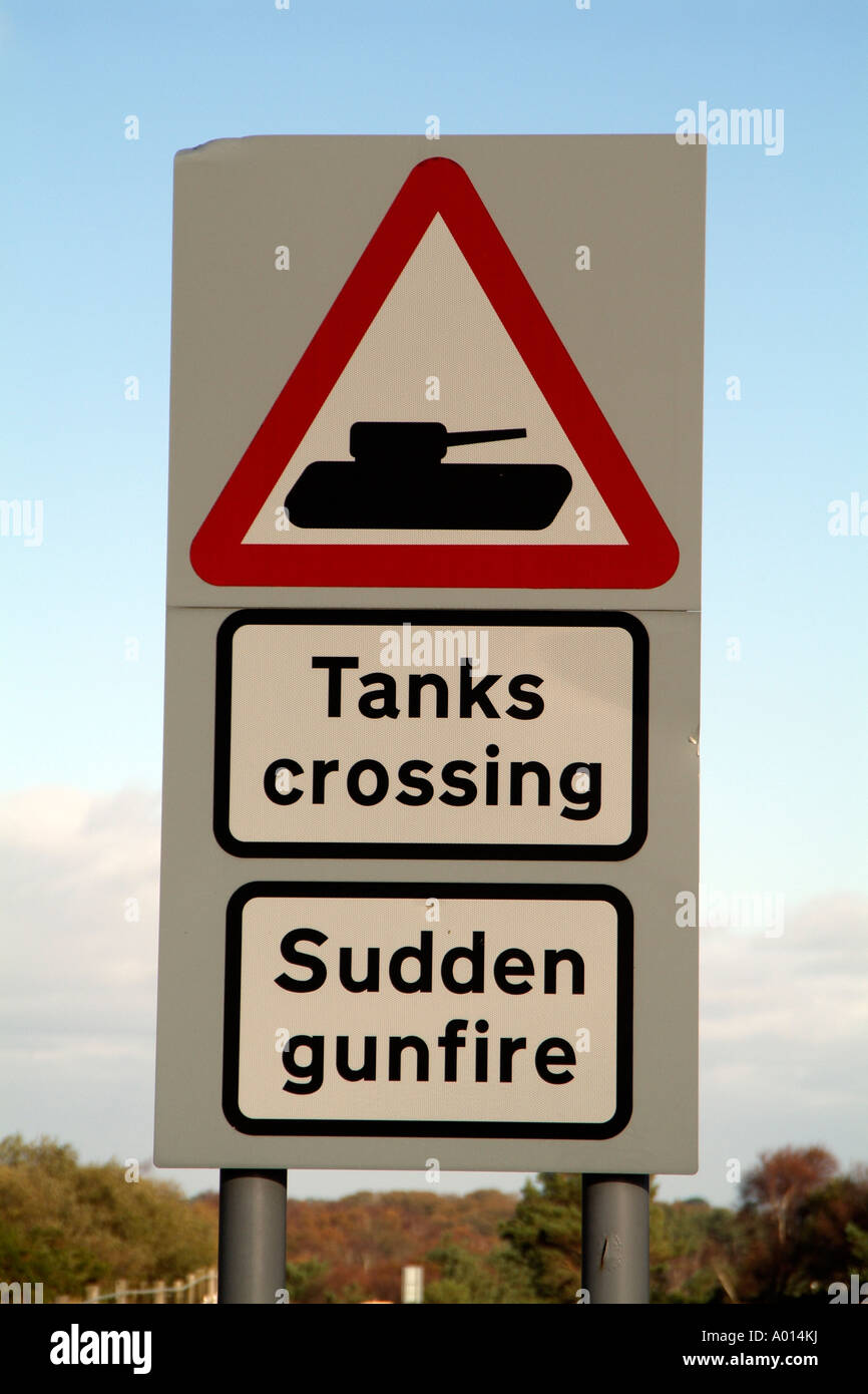 Warning road sign. Tanks crossing and sudden gunfire Stock Photo - Alamy