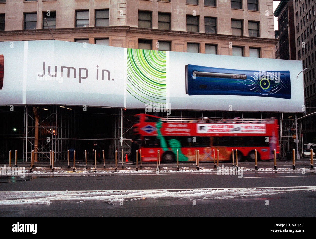 A tourist sightseeing bus passes a billboard in New York City for the ...