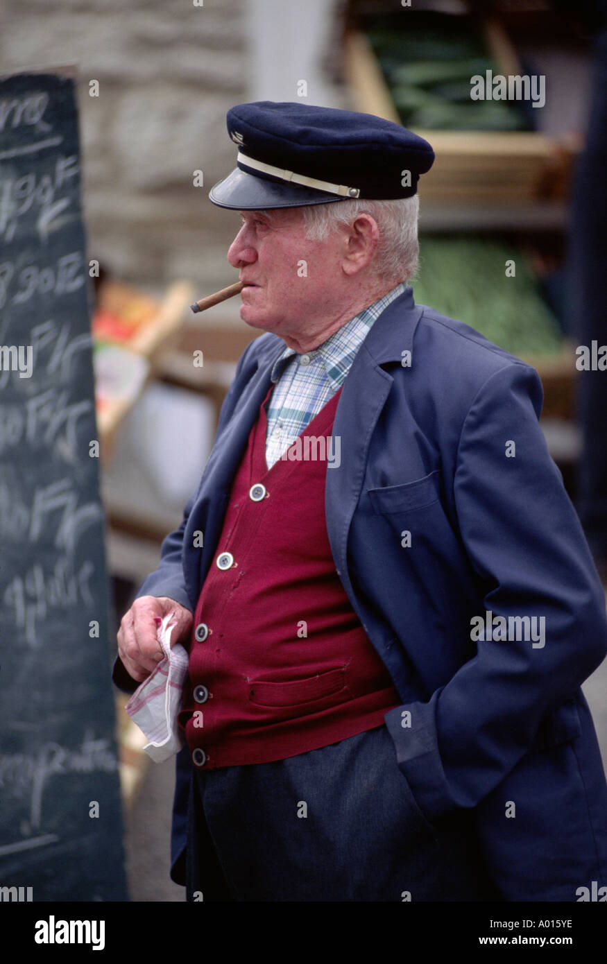 Frenchman smoking a cigar in the golden stone village of GORDES ...