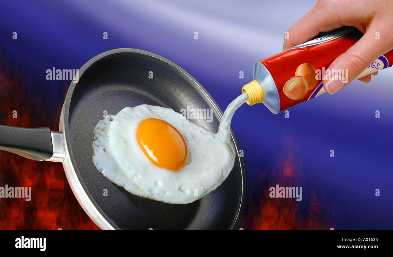 egg squeezed into a frying pan over fire Stock Photo - Alamy