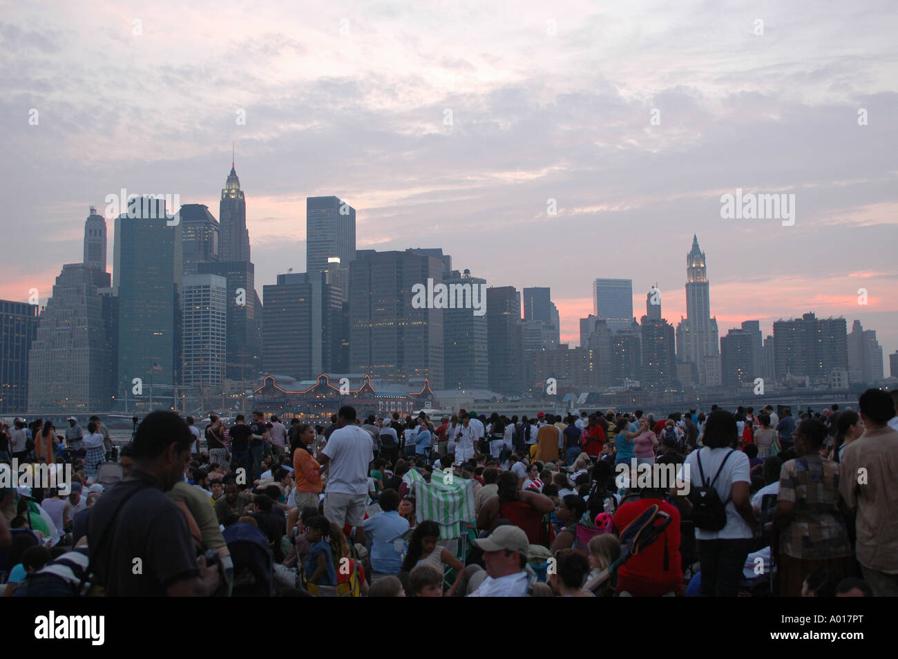NYC Crowd under Brooklyn Bridge Park overlooking downtown Manhattan ...