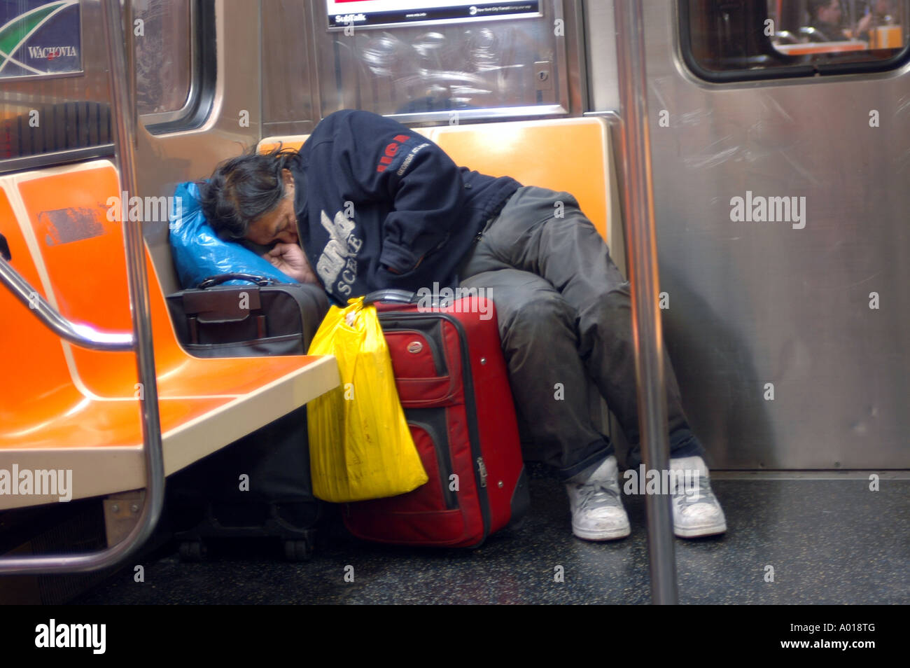 Homeless man sleeping in subway hi-res stock photography and images - Alamy