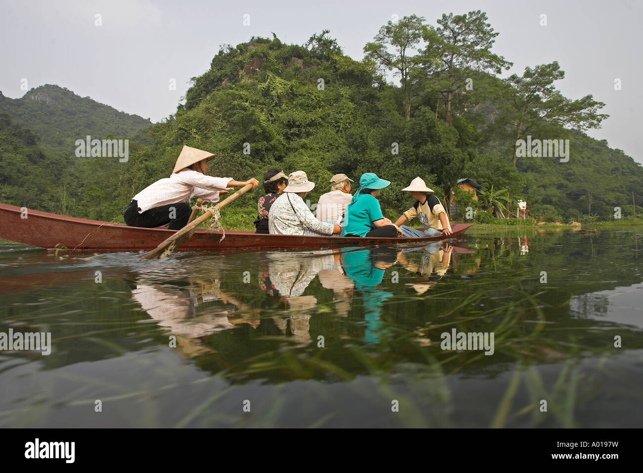 Conical hat woman rows tourists to Perfume Pagoda Vietnam Stock Photo ...