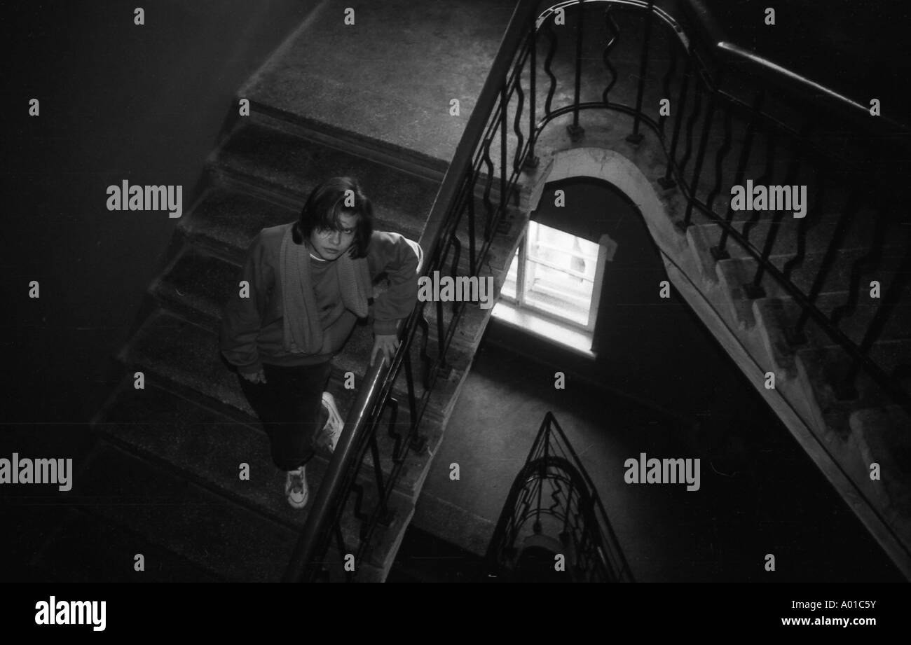 Girl standing on the stairs in an old building Stock Photo - Alamy